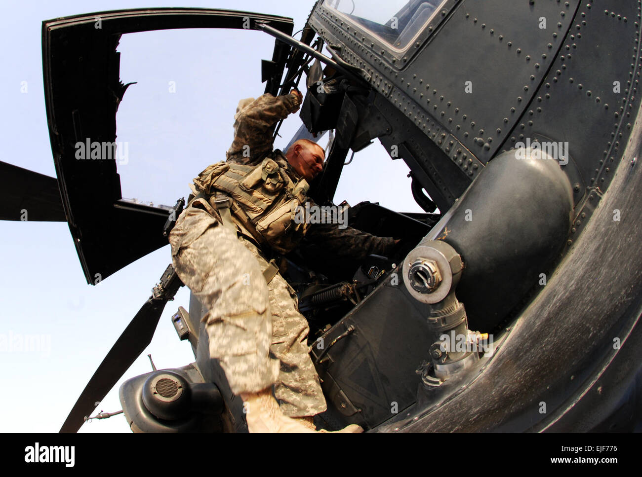 An Apache attack helicopter pilot serving in Iraq with the Enhanced ...