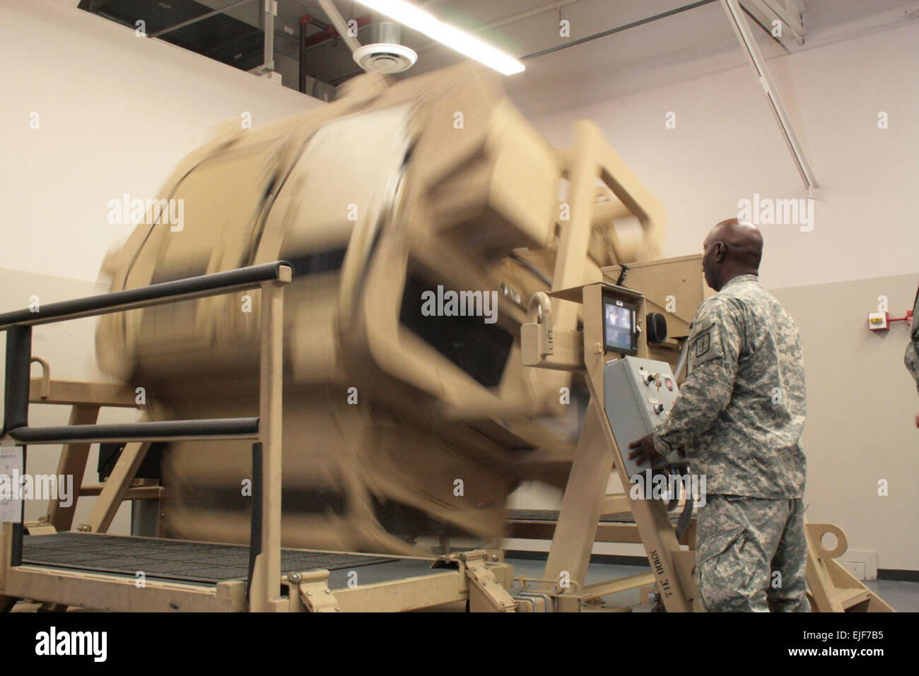 U.S. Army competitors go through the HMMWV Egress Assistance Trainer ...