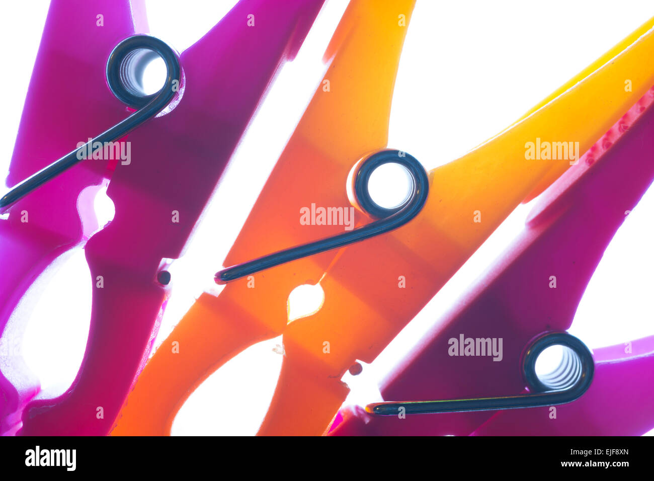 Colourful translucent clothes pegs Stock Photo - Alamy