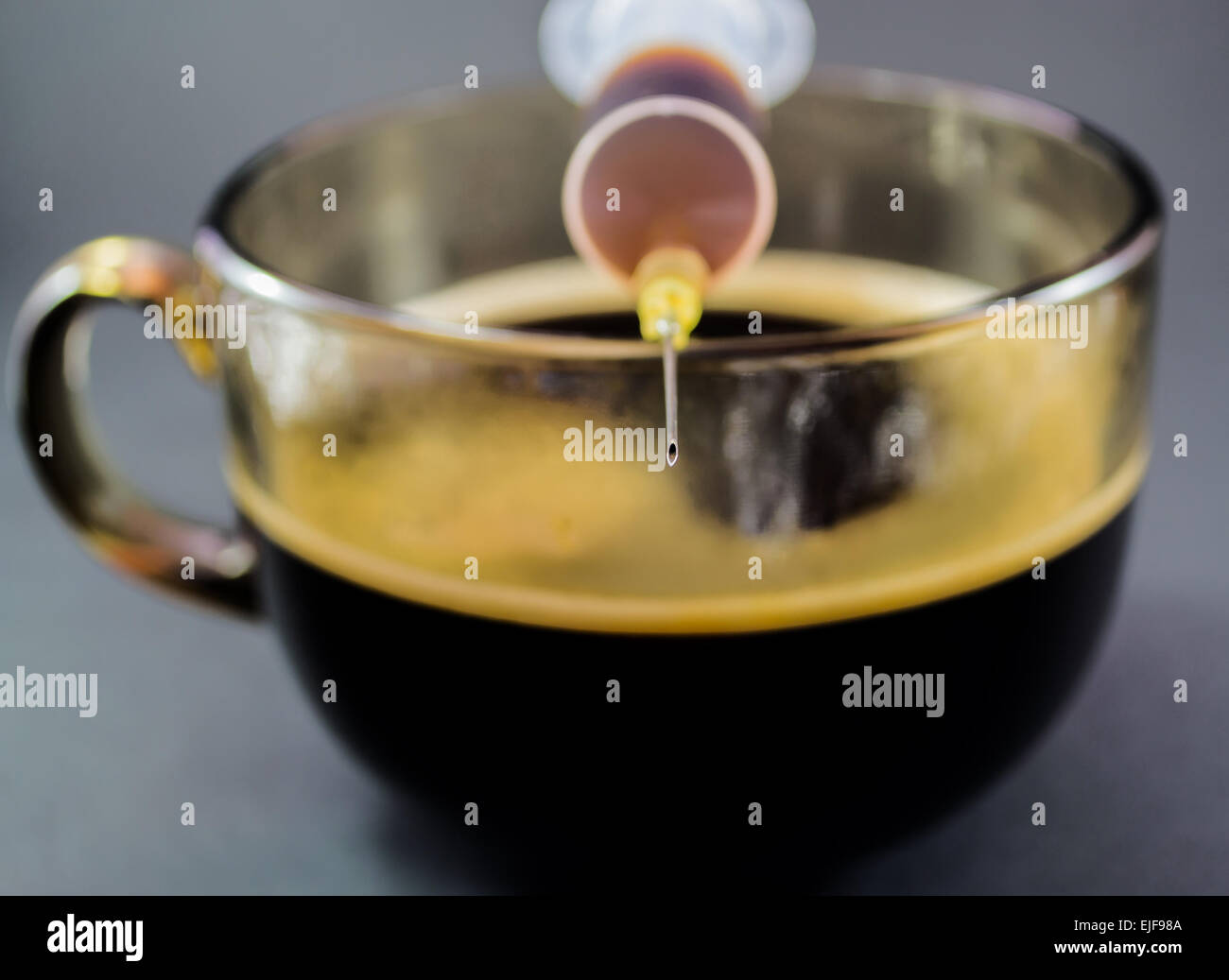 A full medical needle rests on top of a coffee cup Stock Photo - Alamy