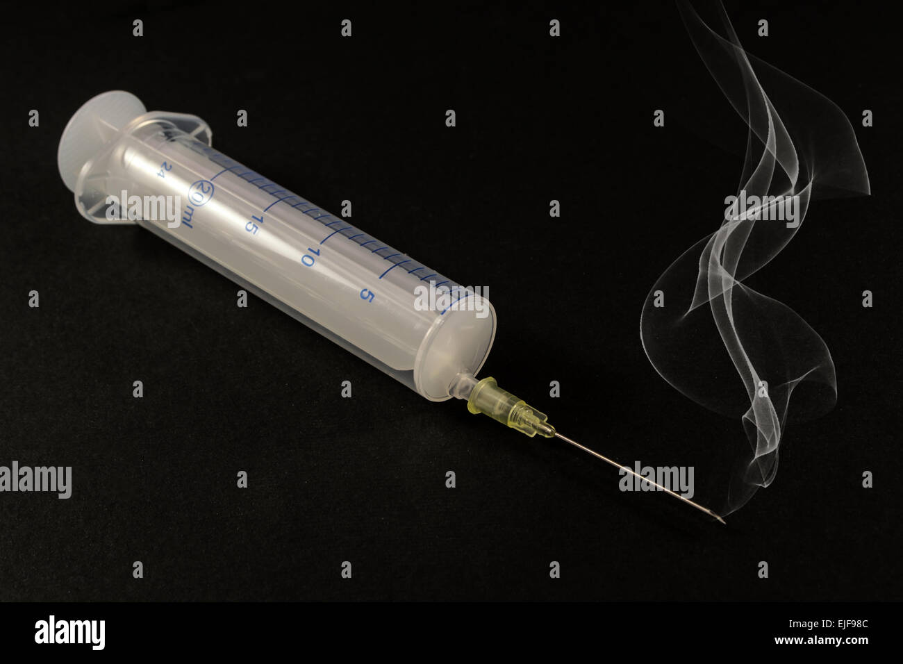 A complete unused medical syringe sitting on a grey background Stock ...