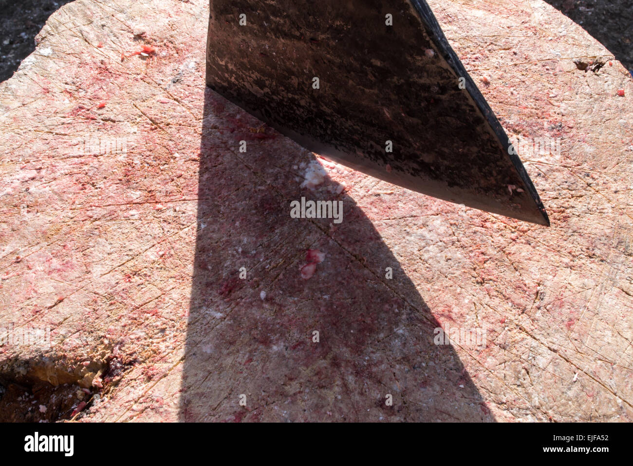 A butchers chopping axe stuck in a wooden chop block Stock Photo - Alamy