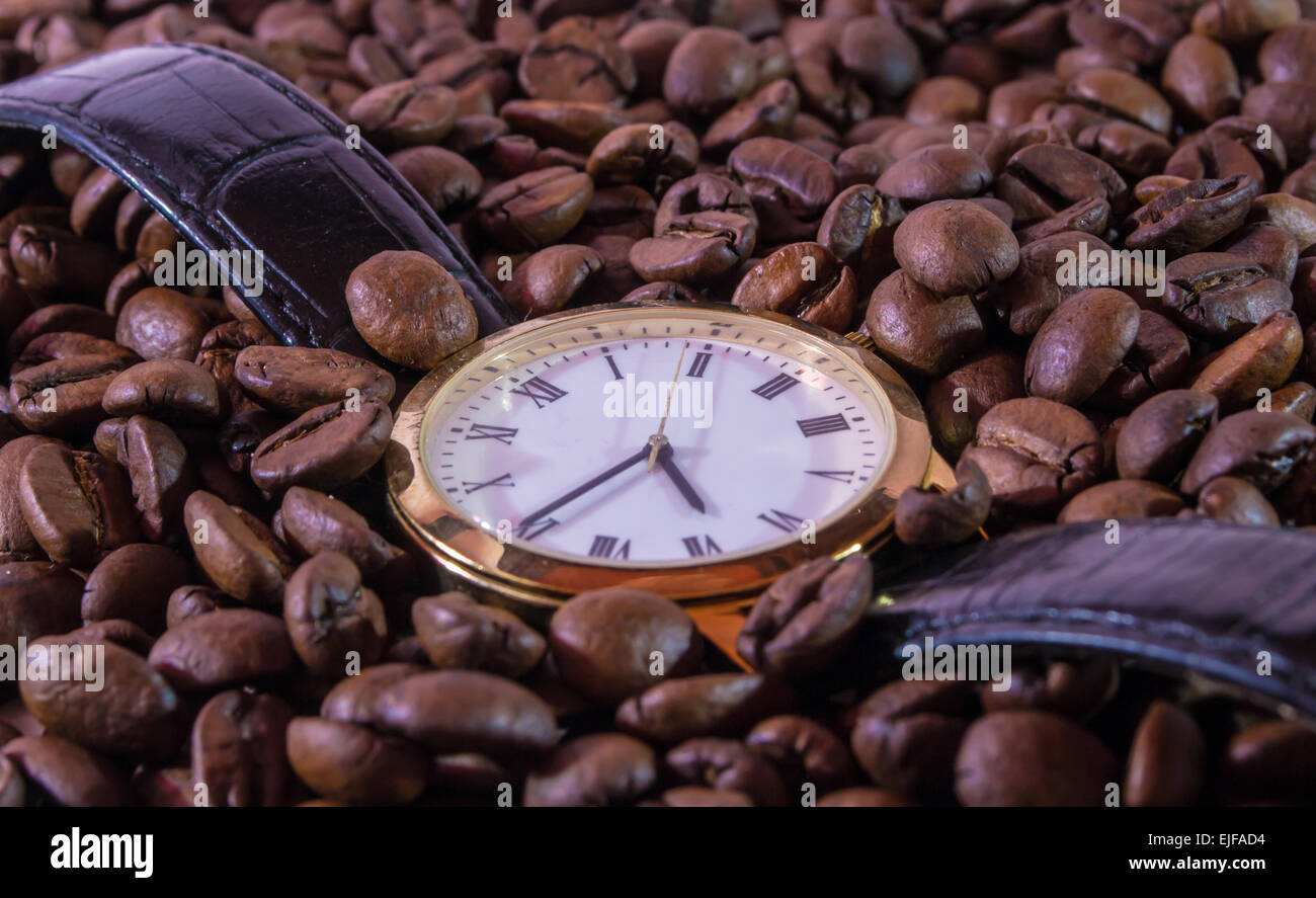 Fresh organic coffee beans and a leather and gold watch time for coffee ...