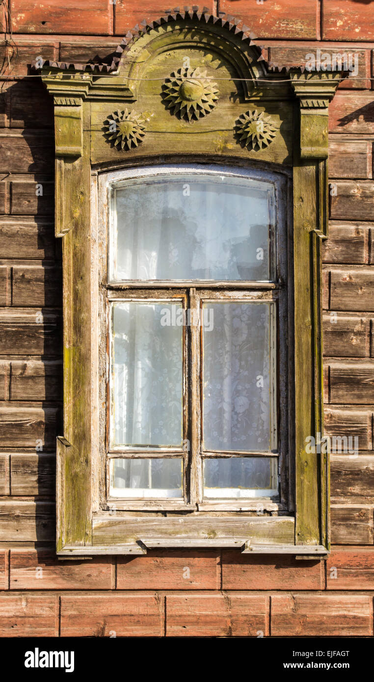 A fading green painted ornate Russian window frame on a public house ...