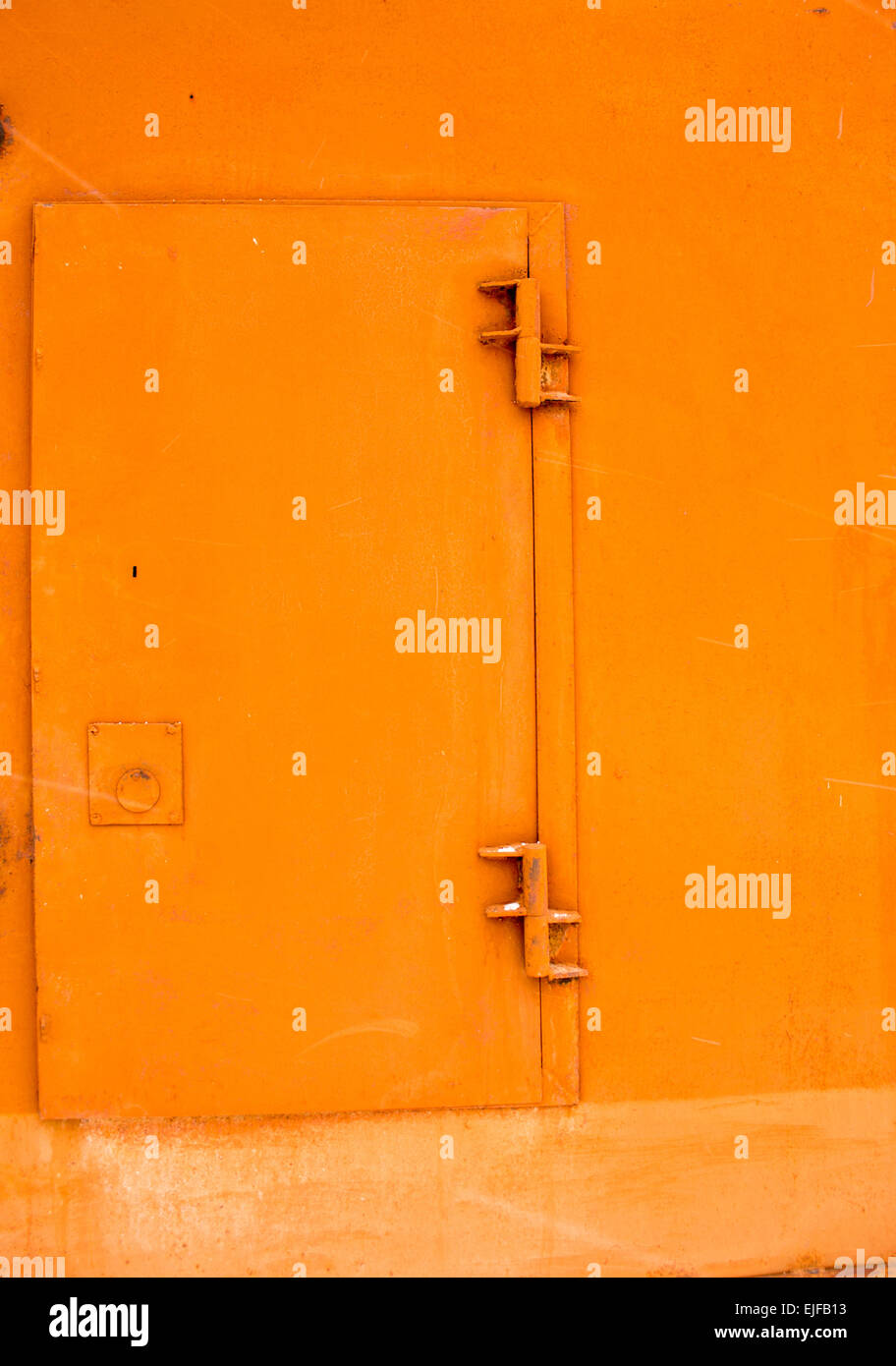 A handpainted bright orange door with hinge Stock Photo - Alamy