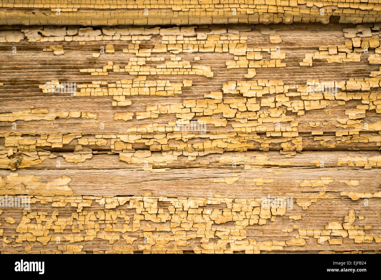 Yellow painted wood with signs of age and weather effects Stock Photo ...