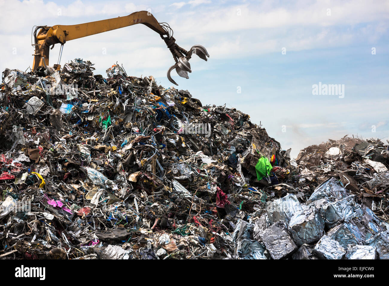 Grab machine organising metal recycling of scrap metal to avoid ...