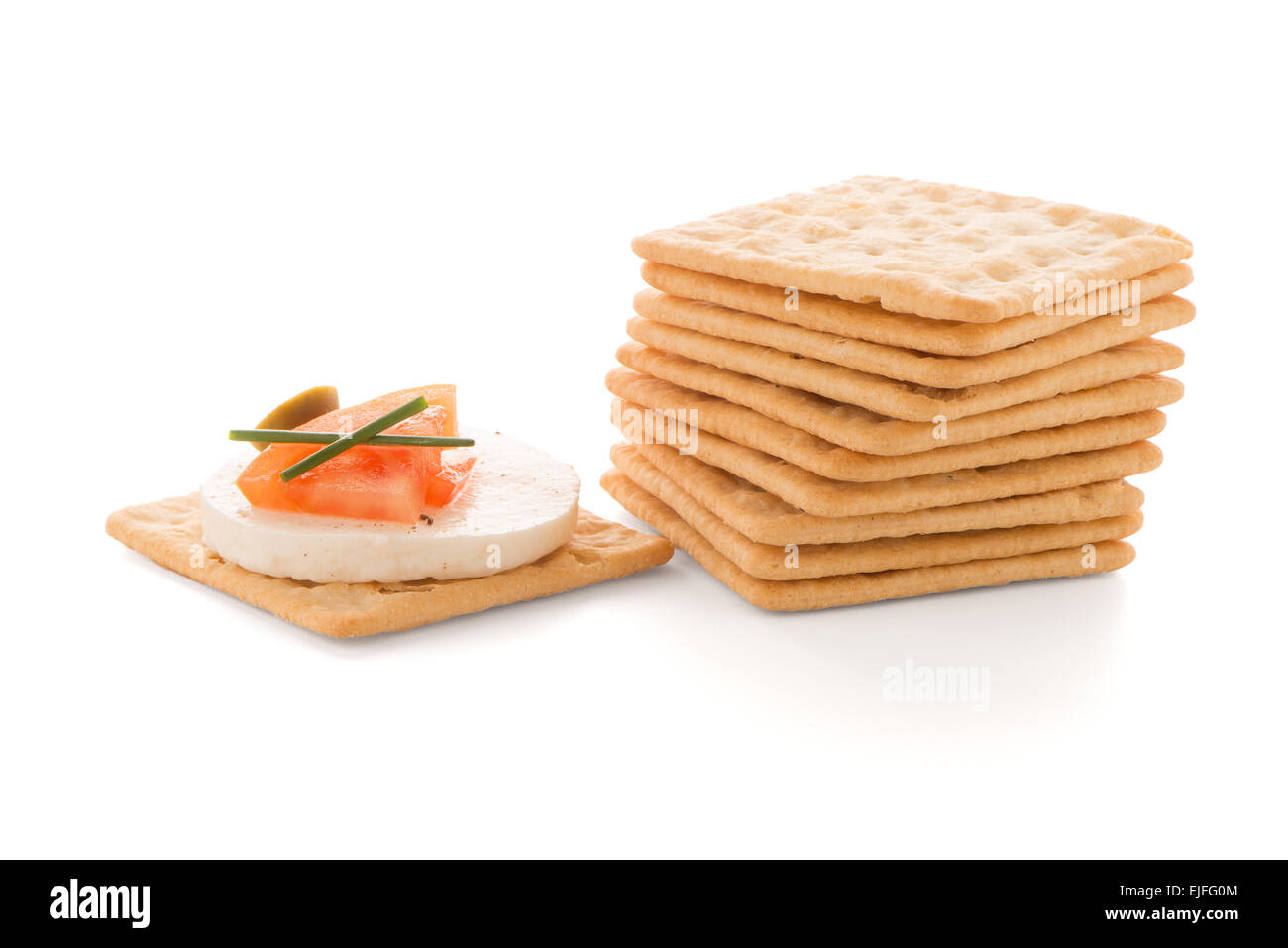 Crackers with cheese and tomato isolated on white background Stock ...