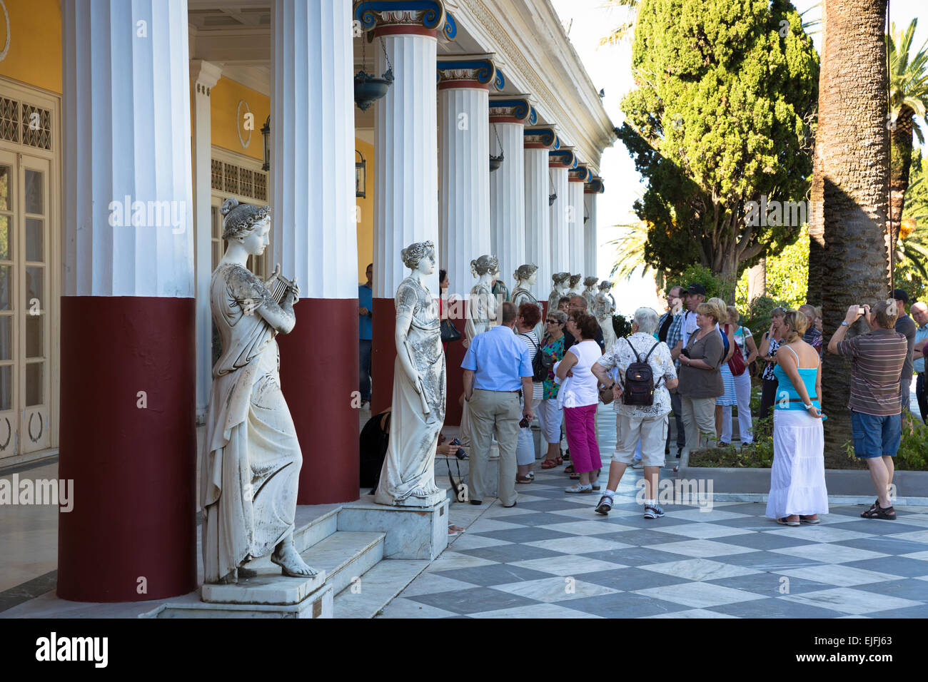 Tourists view stone statues at Achilleion Palace, Museo Achilleio, in ...