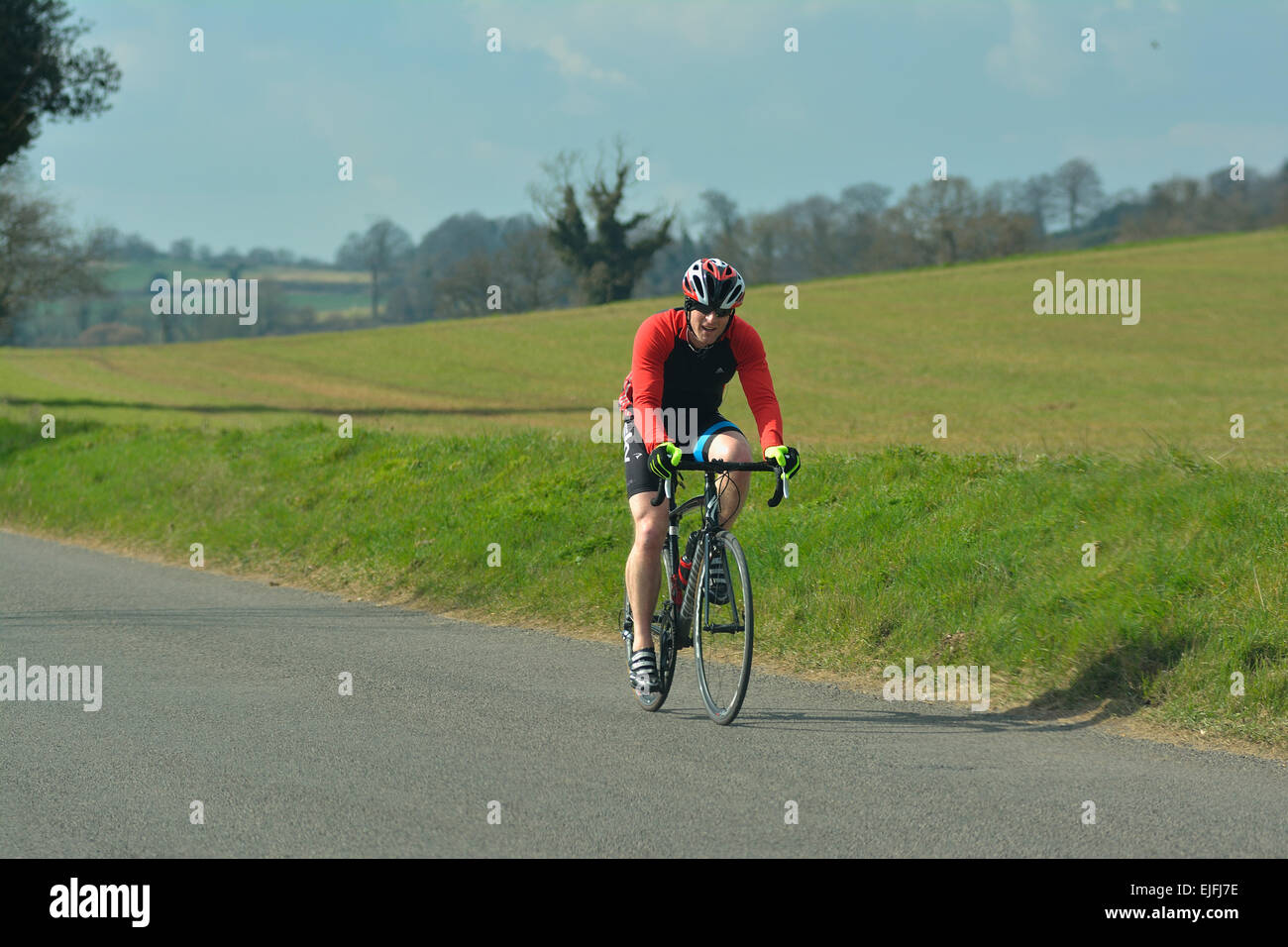 Cycling on a country lane in Bedfordshire, England, UK Stock Photo - Alamy