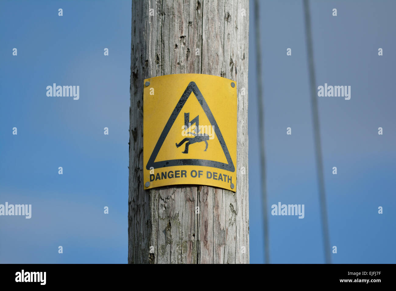 Danger of Death warning sign on wooden pole carrying electricity supply ...