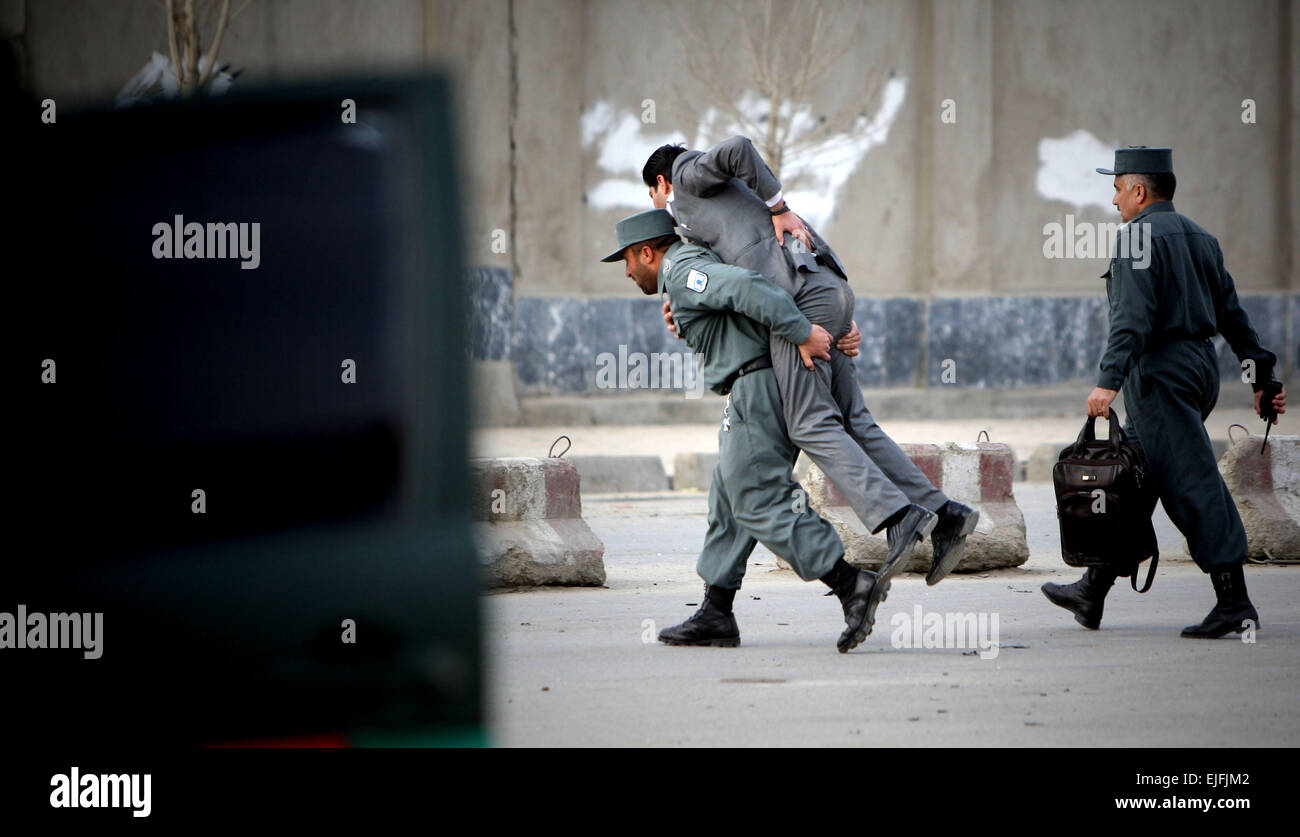 Kabul, Afghanistan. 25th Mar, 2015. An Afghan policeman carries a ...