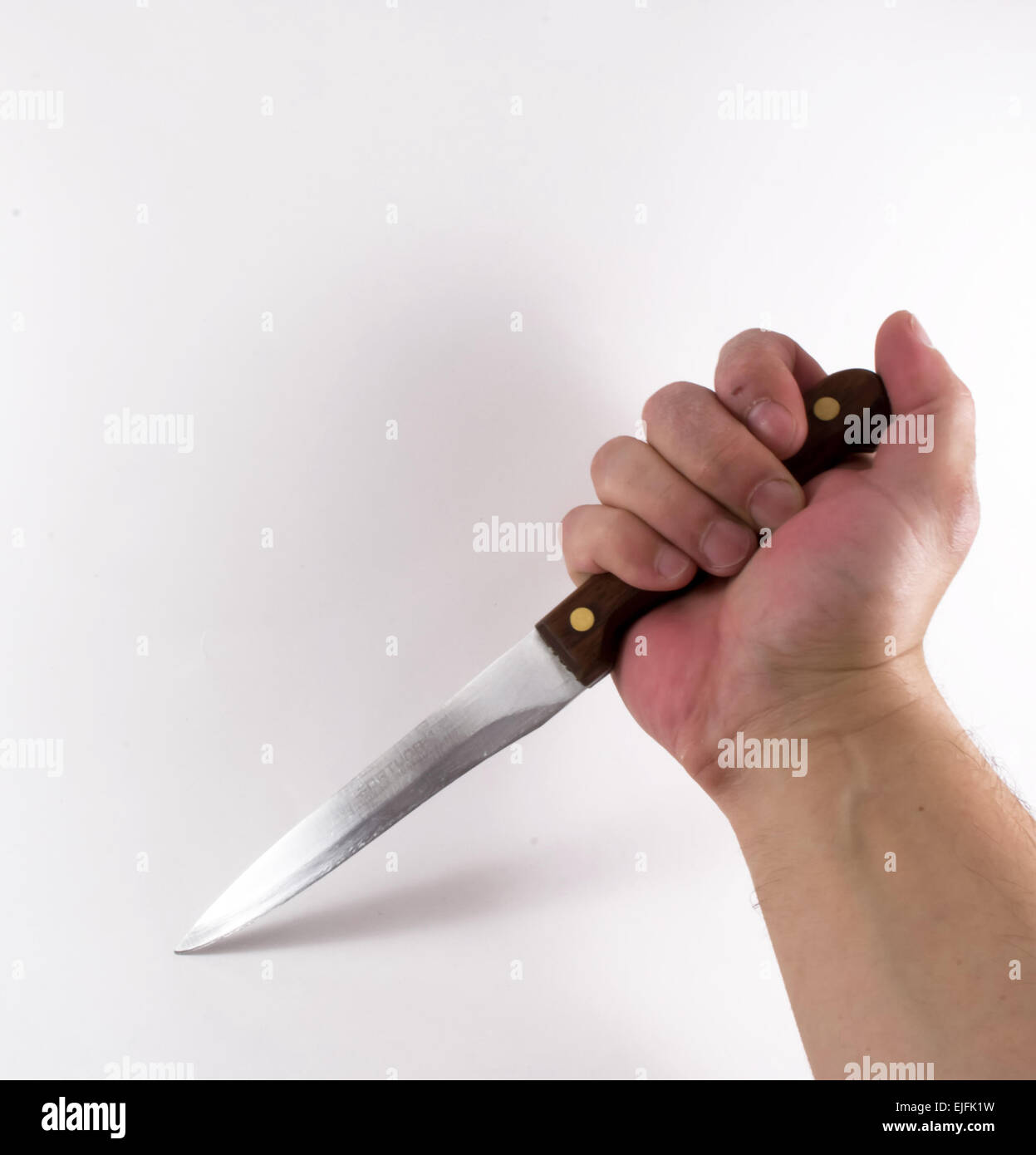 A man's hand holding a knife in a stabbing gesture Stock Photo - Alamy