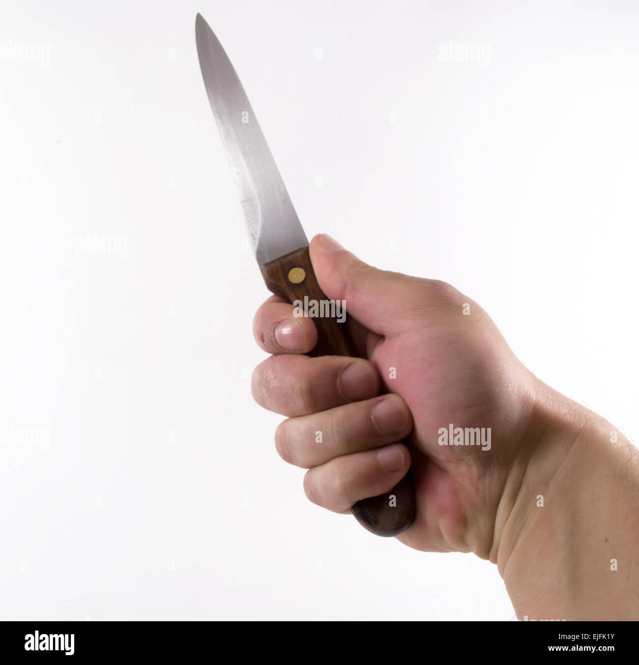 A man's hand holding a knife in a stabbing motion Stock Photo - Alamy
