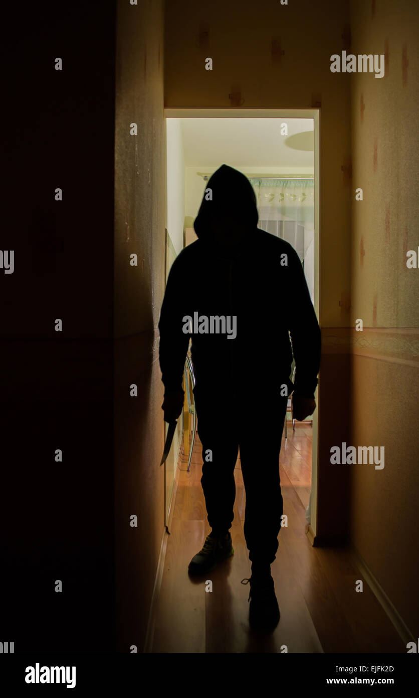 A burglar man with a knife in darkness Stock Photo - Alamy