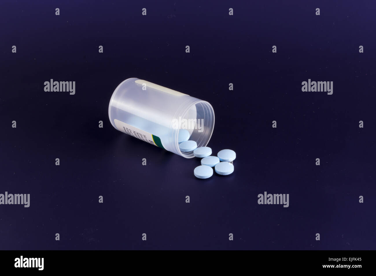 Lots of Blue medcine tablets on a blue background Stock Photo - Alamy