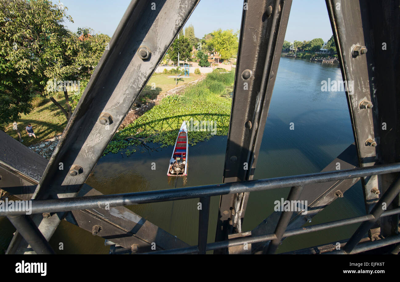 A boat sits under the Death Railway Bridge over the River Kwai ...