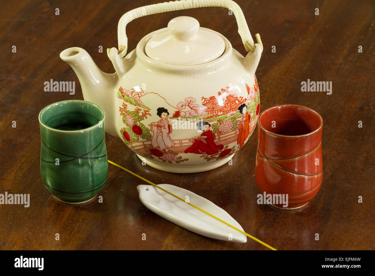 Tea pot with two tea cups and incense Stock Photo - Alamy