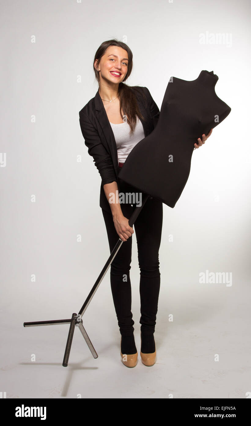 Young Woman tailor holding on Mannequin Stock Photo - Alamy