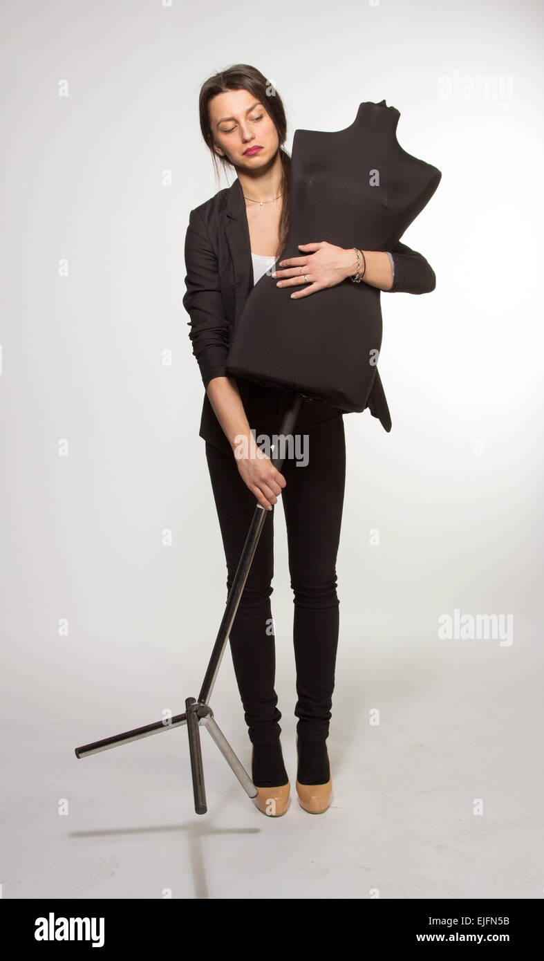 Young Woman tailor holding on Mannequin Stock Photo - Alamy