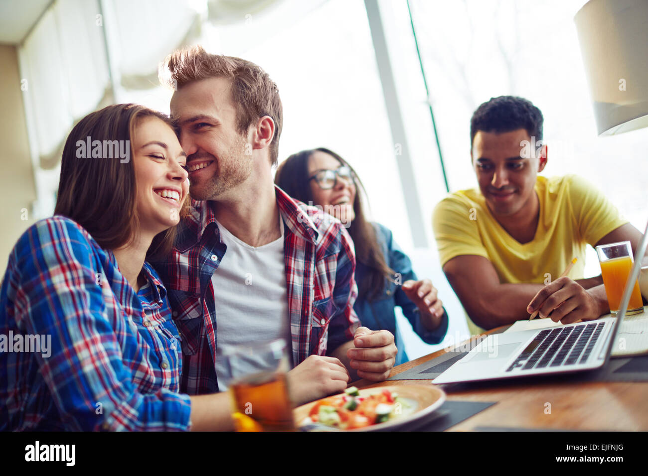 Group of students having dinner and working with computer Stock Photo ...