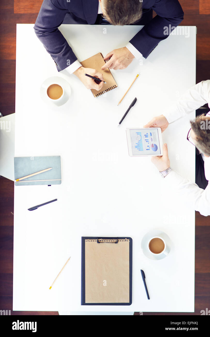 Two men working at office table Stock Photo - Alamy