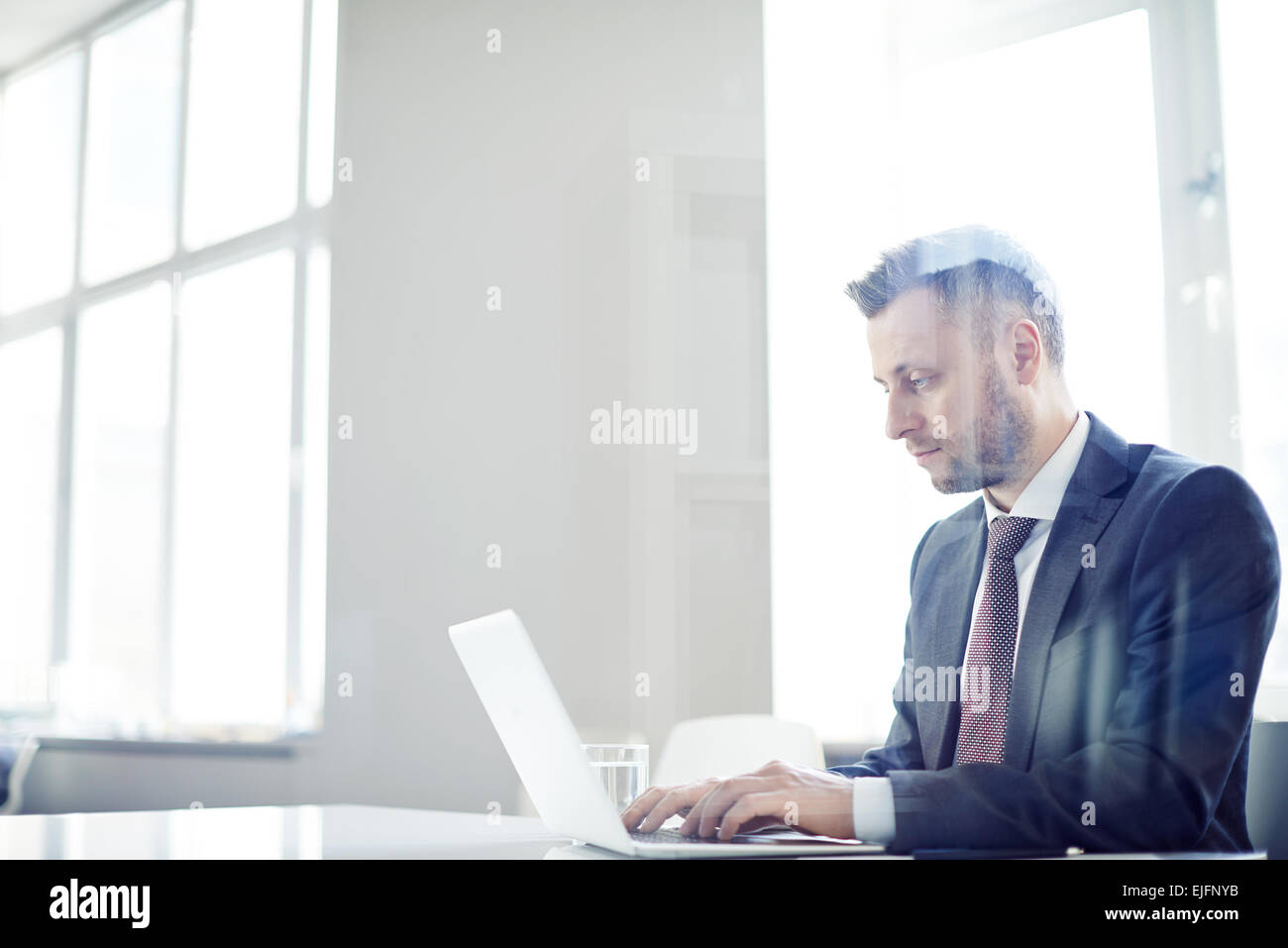 Busy man typing on computer Stock Photo - Alamy