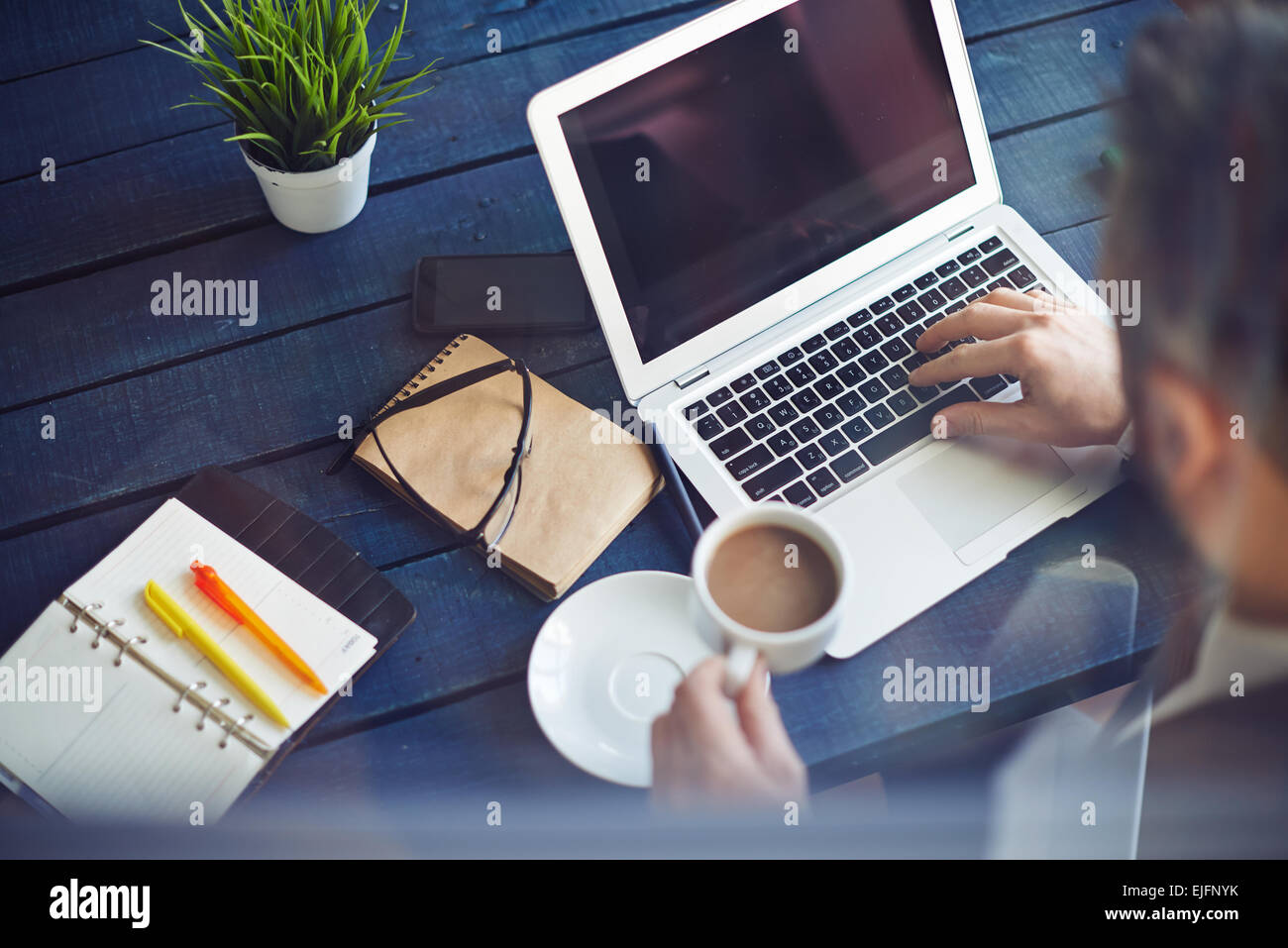 Businessman working with laptop at office table Stock Photo - Alamy