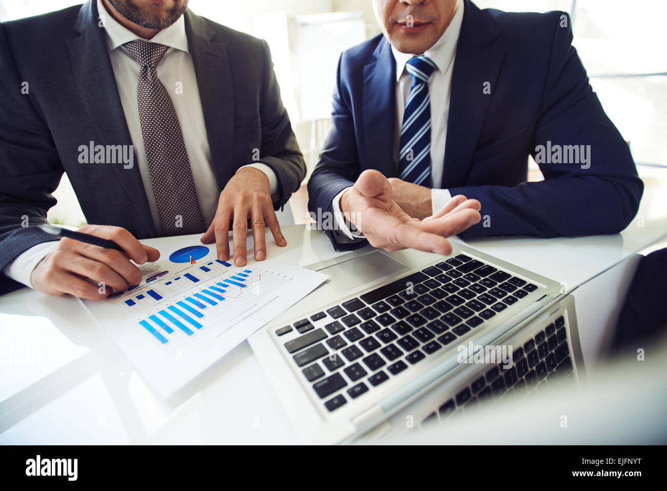 Two men in suits searching for decision in financial issues Stock Photo ...