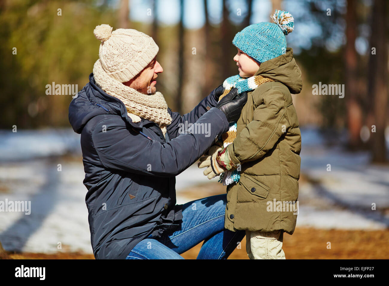 Careful father knotting scarf on son Stock Photo - Alamy