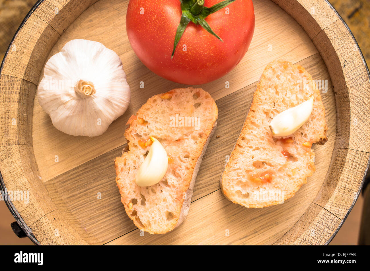 Spanish tapas with tomato garlic head on the barrel. Top view Stock ...