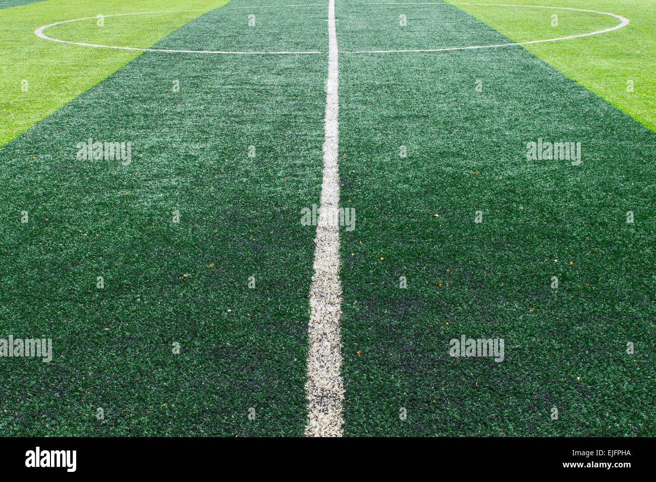 White center line of soccer field. Center line on artificial grass ...