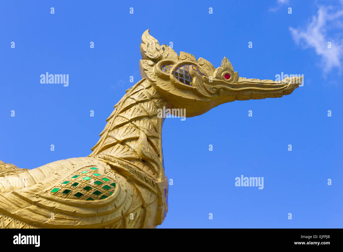 Thai golden swan statue with red eye on blue sky background. Golden ...