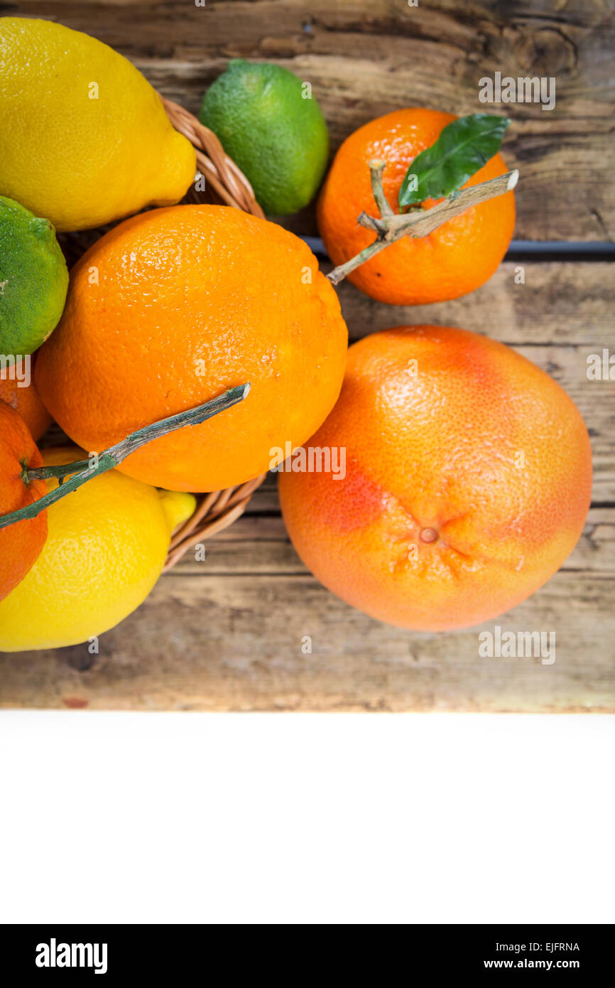 Citrus fruits mix on a wooden background Stock Photo - Alamy