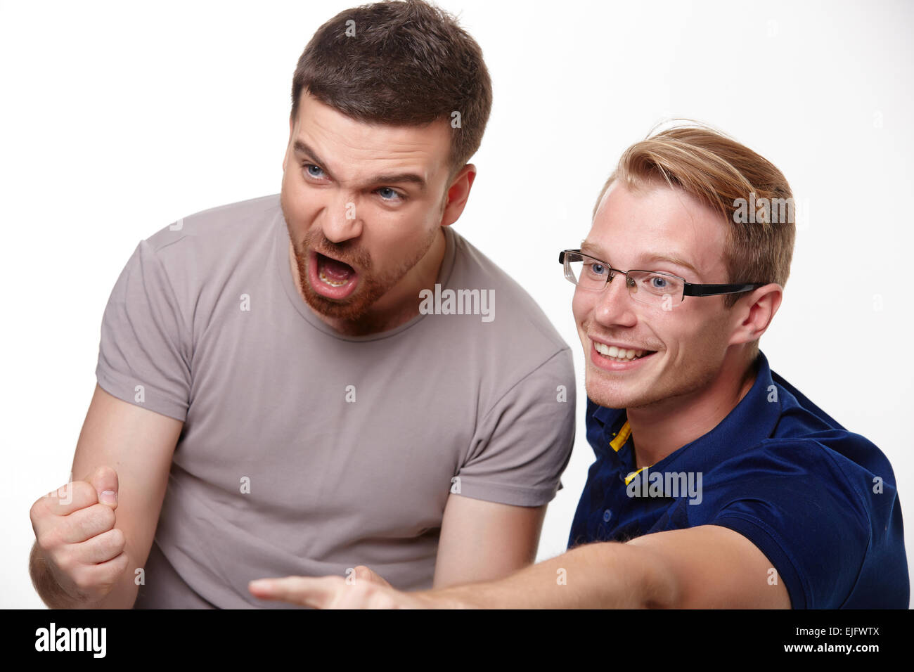 Two young men watching the competition Stock Photo - Alamy