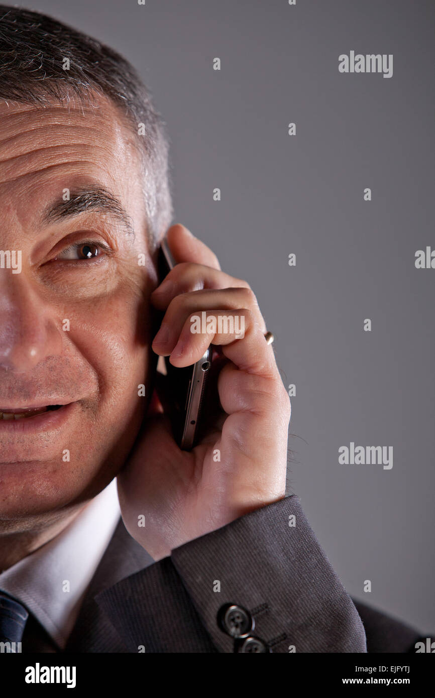 old man using a smartphone on a neutral background Stock Photo - Alamy