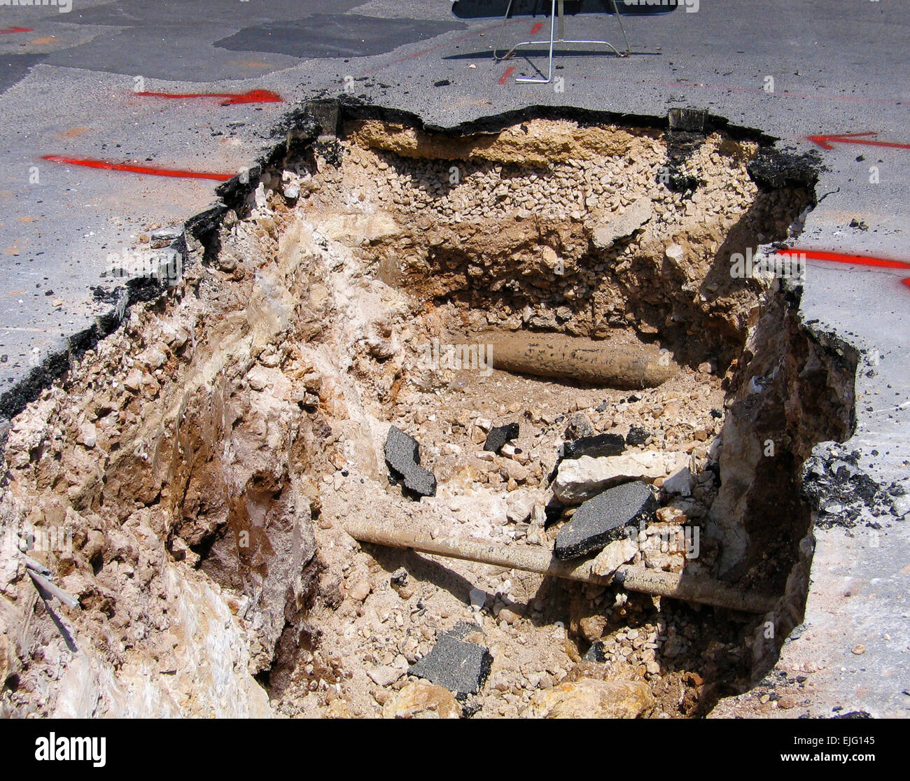 Cut away cross section of a road where maintenance work is being ...