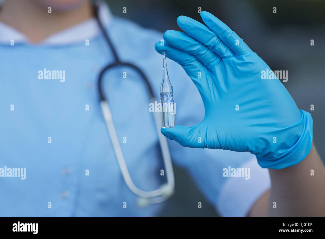 female doctor holding a vial Stock Photo - Alamy
