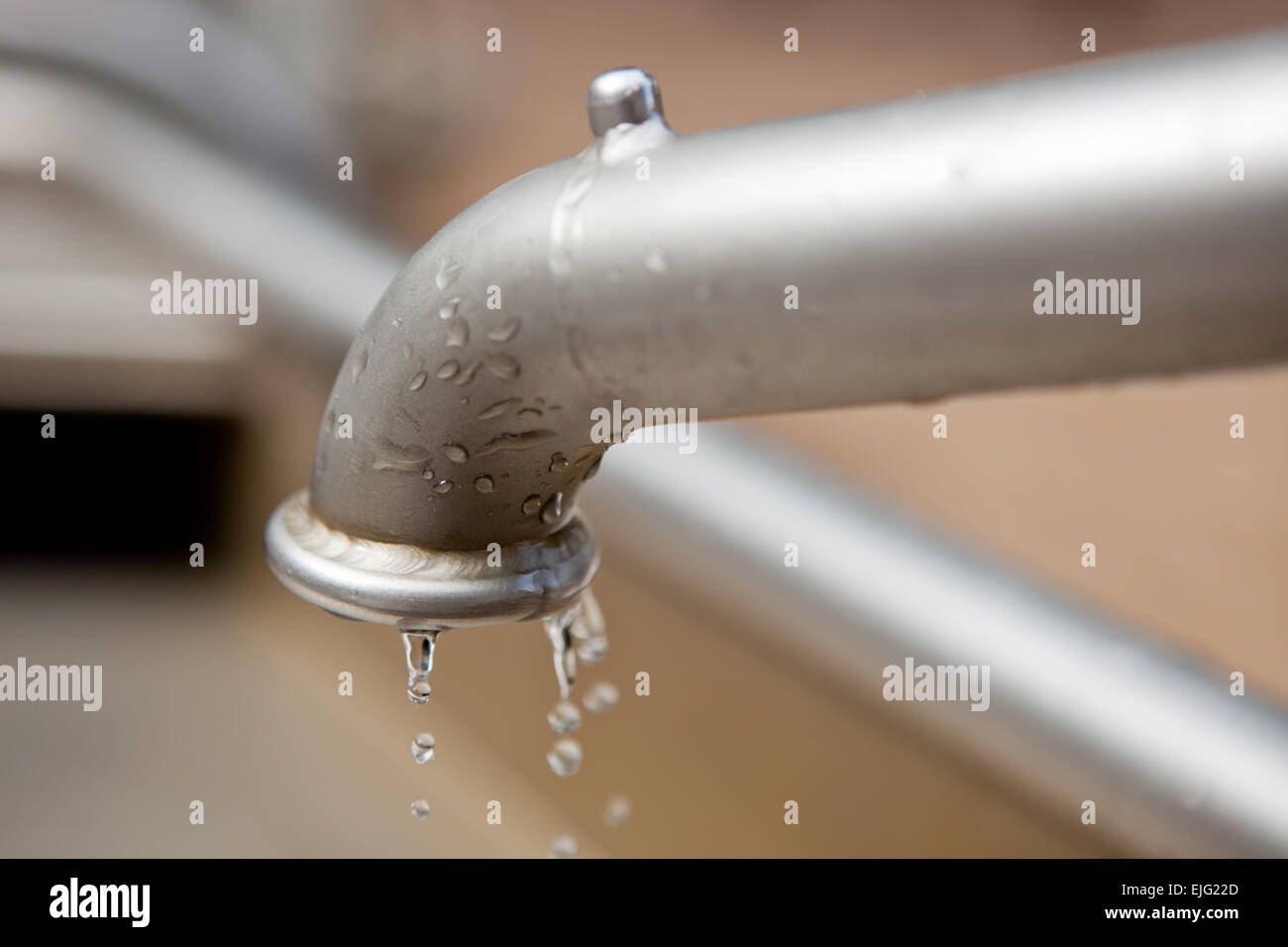 Water drops flowing from metal clean water tap Stock Photo - Alamy