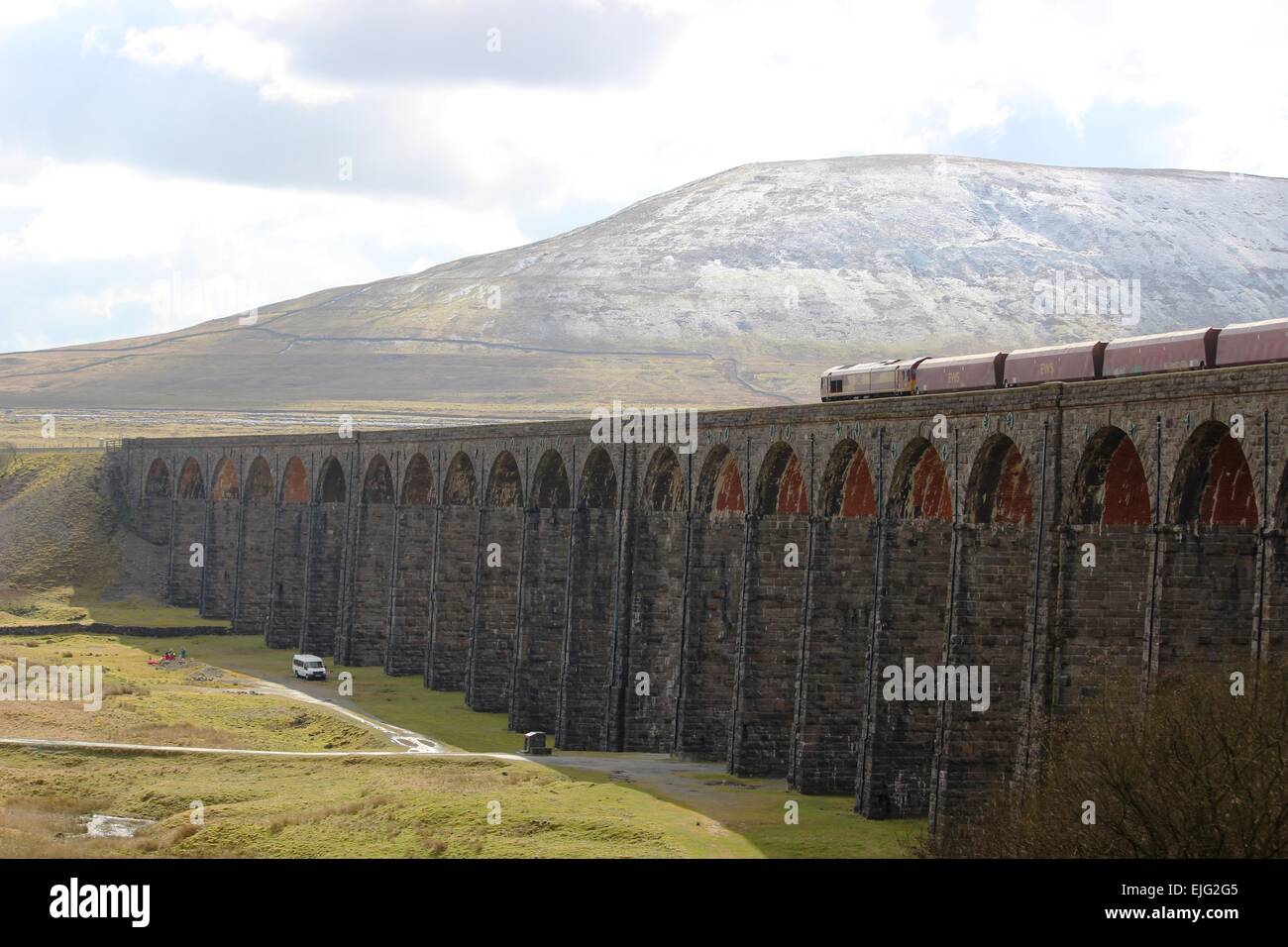 Class 66 diesel locomotive with coal train crossing Ribblehead viaduct ...
