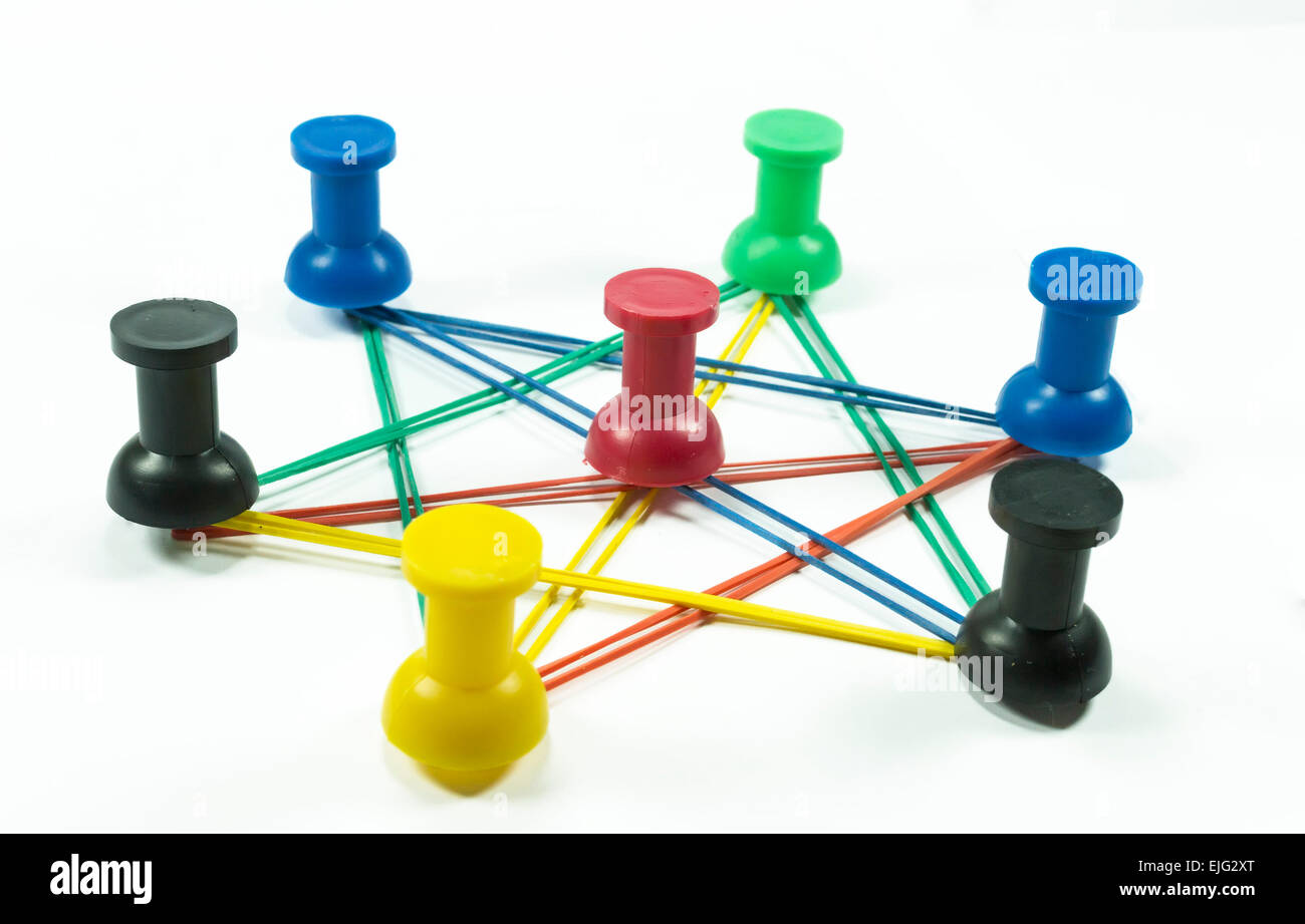 Push pins stuck on a white surface and linked through colored rubber ...