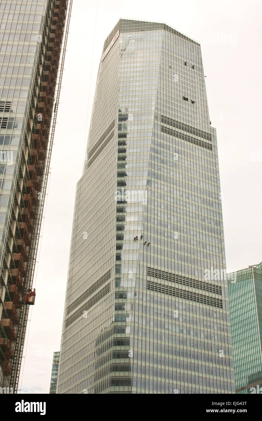 working on a wall high-rise building of modern city Stock Photo - Alamy