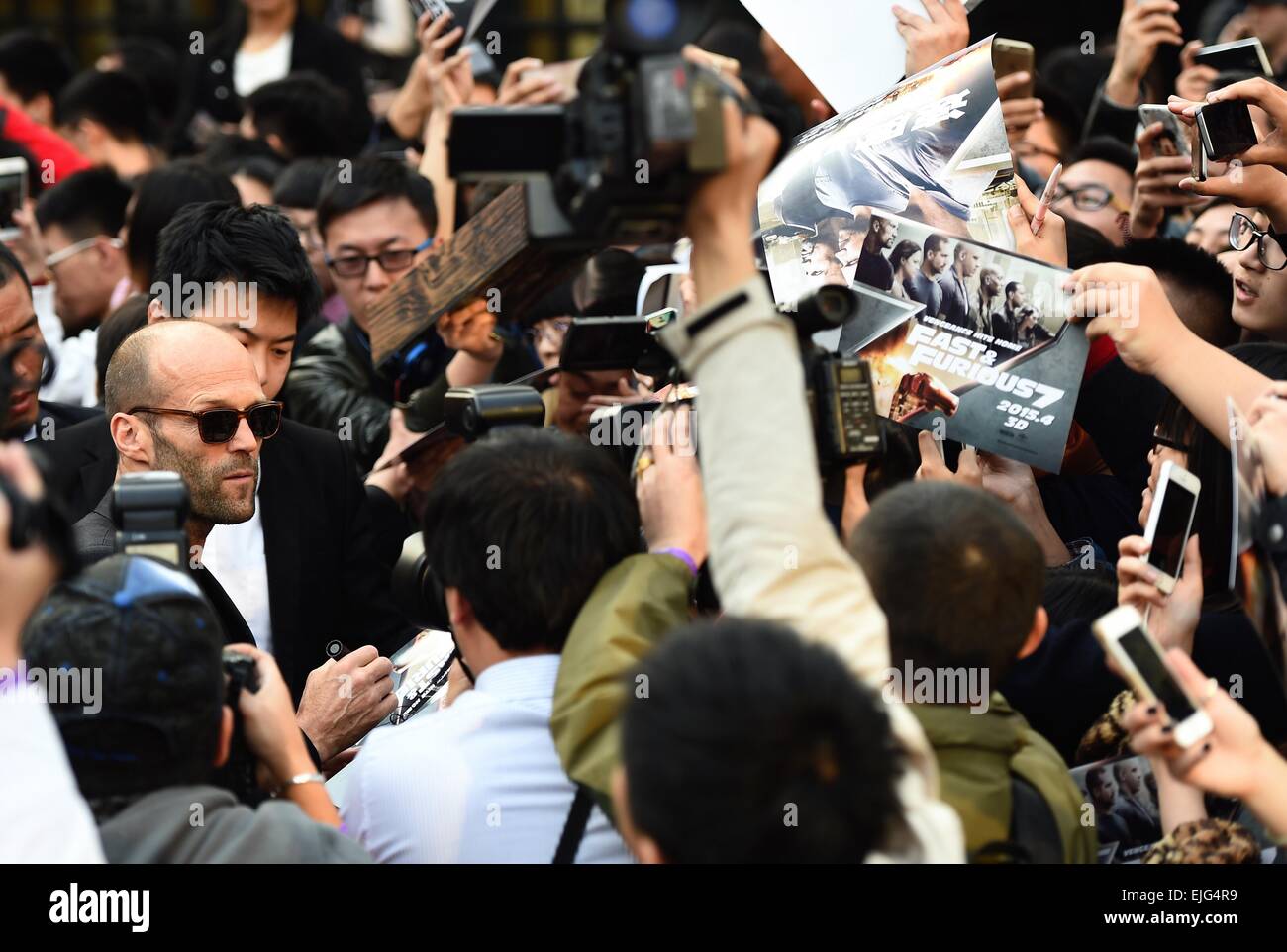 Beijing, China. 26th Mar, 2015. Movie star Jason Statham signs ...