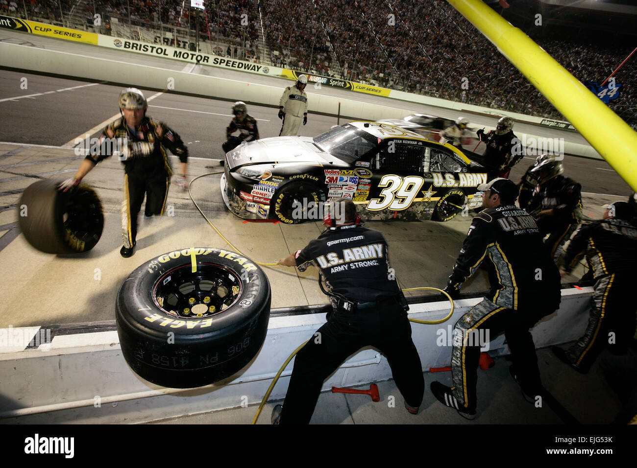 The Army pit crew changes two tires on the Army Chevy Impala following ...