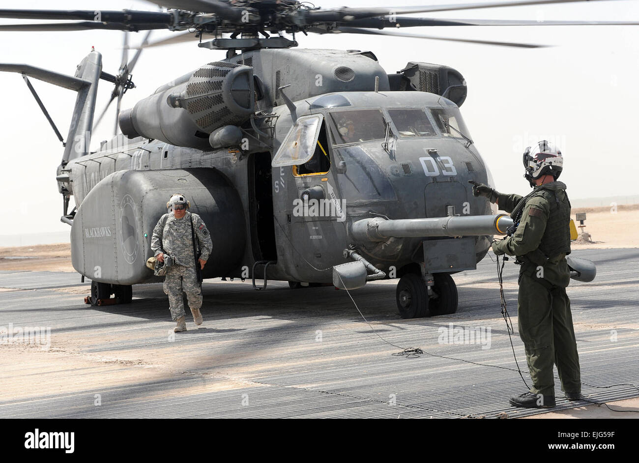 A crewman with Helicopter Mine Countermeasure Squadron 15 directs Army ...