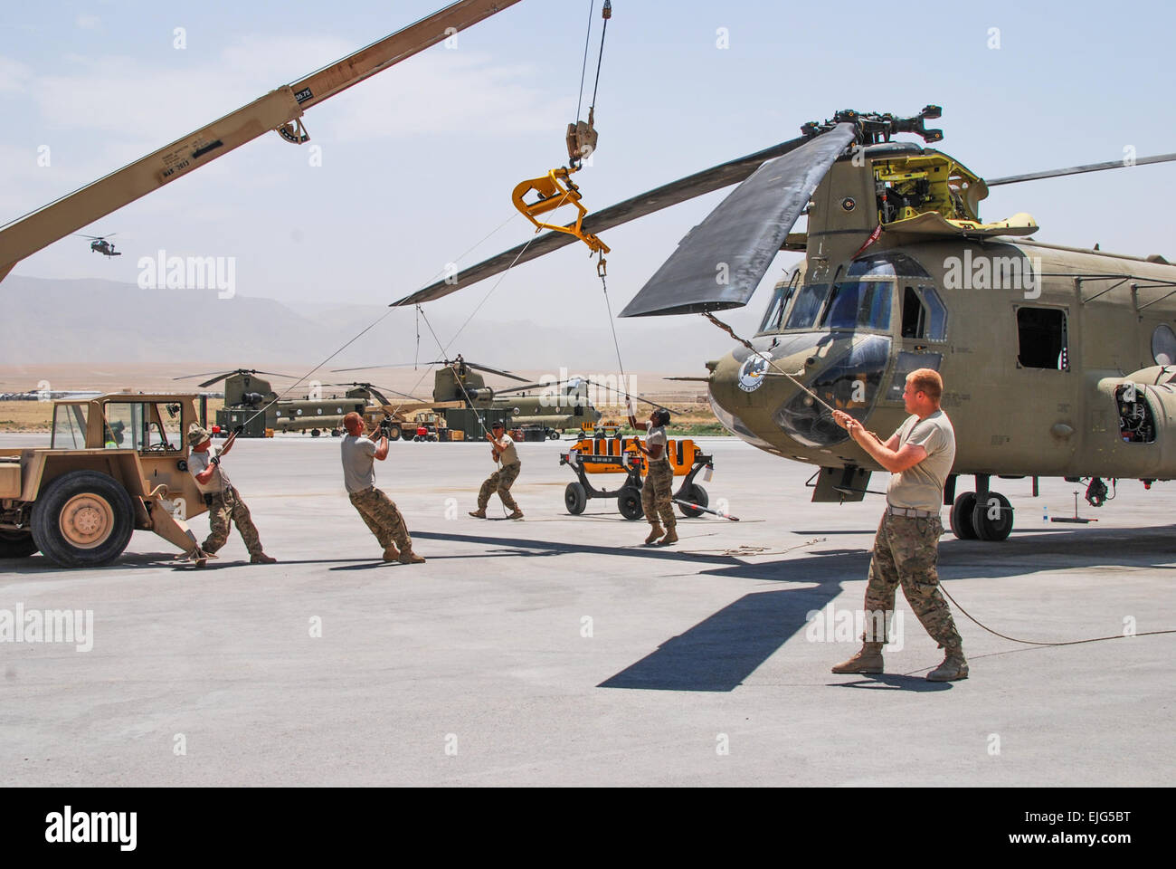 Soldiers from Bravo Company 5-158th Aviation Battalion remove the clamp ...