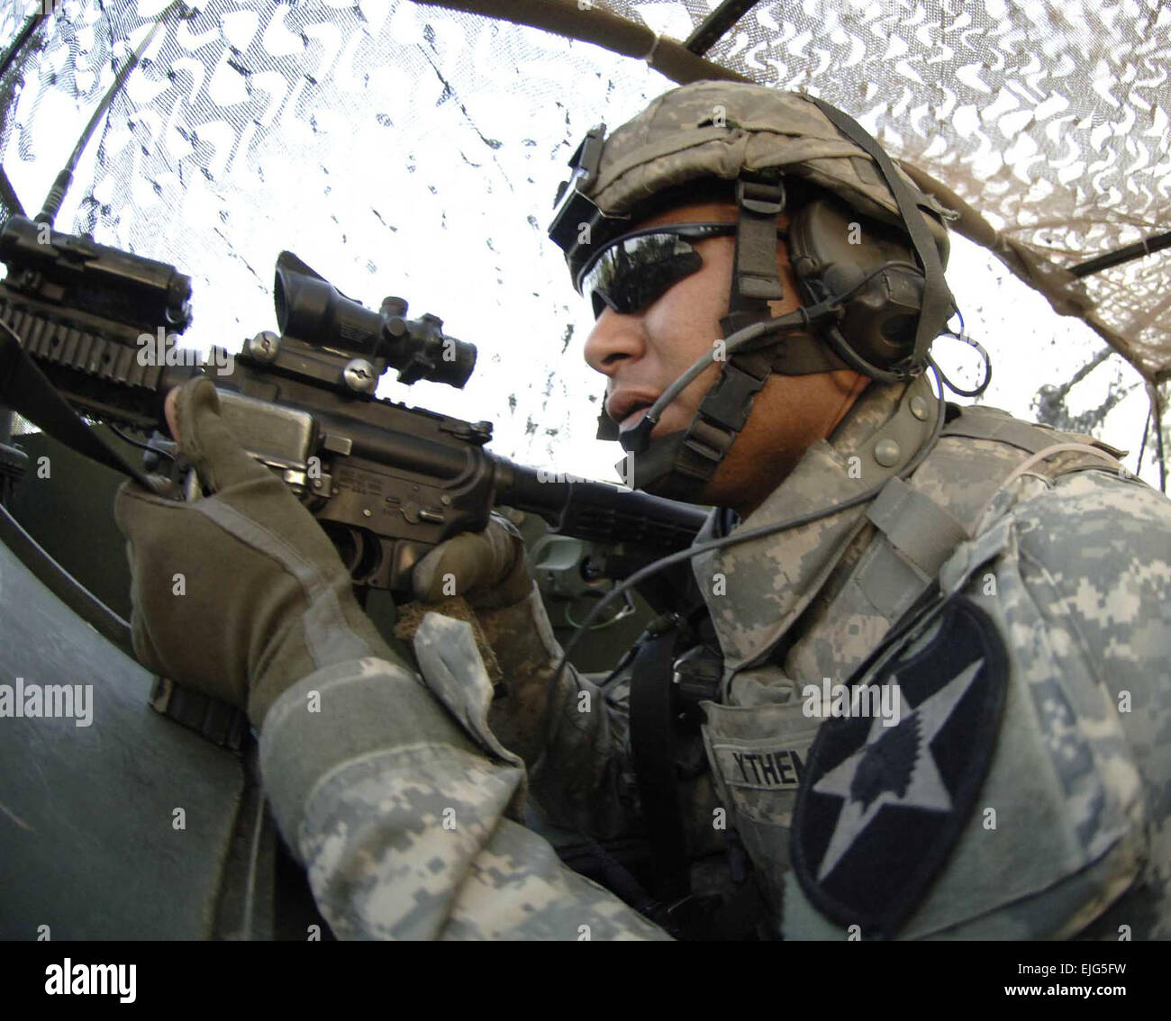 U.S. Army Staff Sgt. Paul Ythemar pulls rear security in the back hatch ...