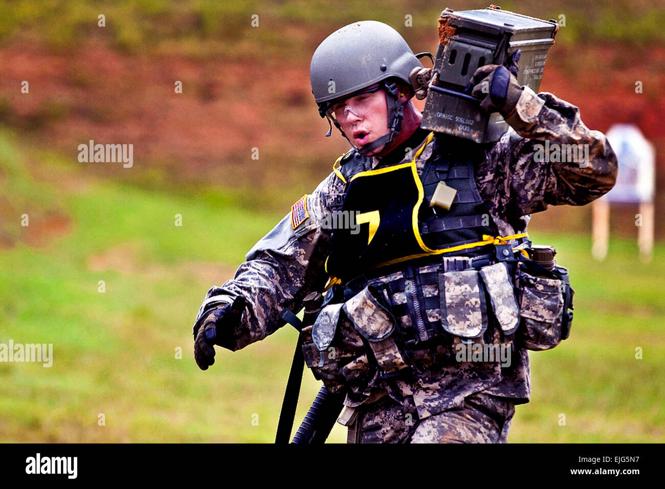 Army Staff Sgt. Beau Detrick carries a fully loaded ammunation box ...
