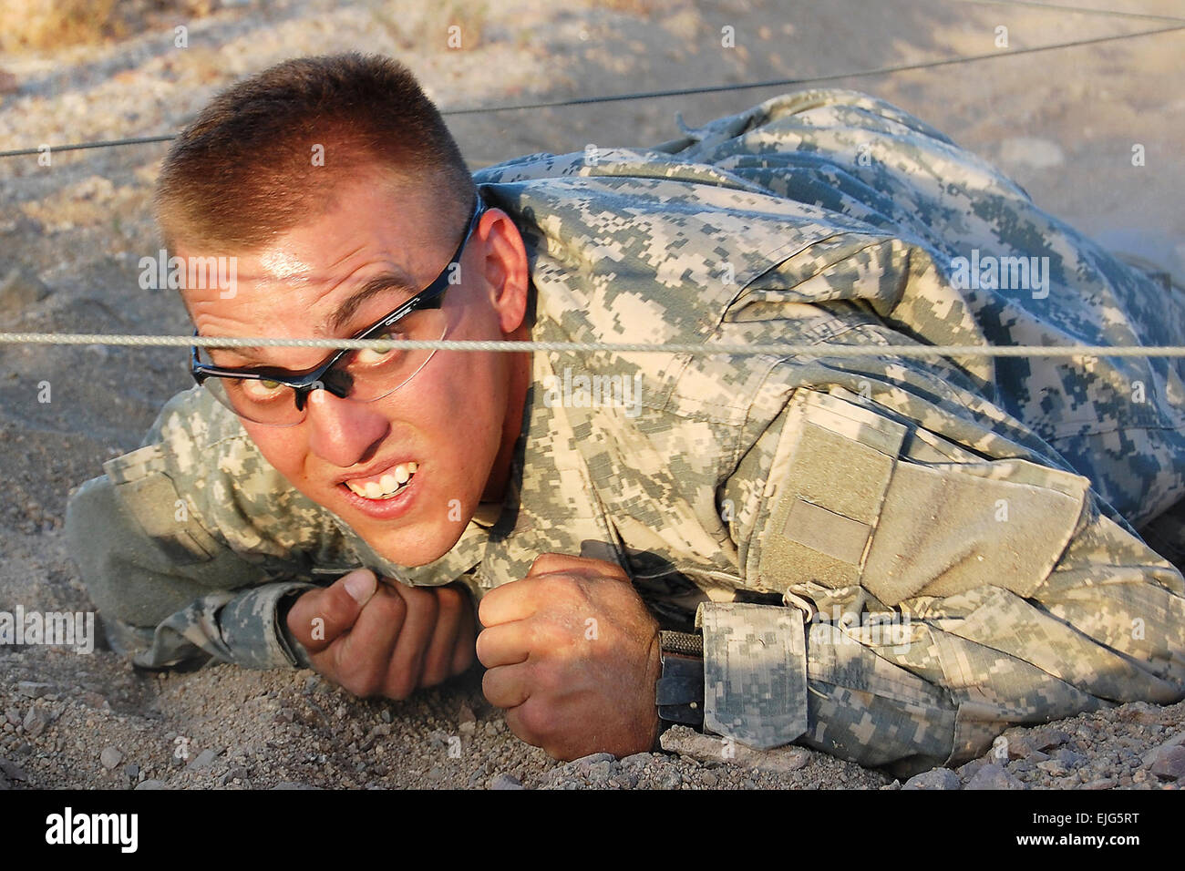 U.S. Army Spc. Daniel Worthington high-crawls through the dirt during ...