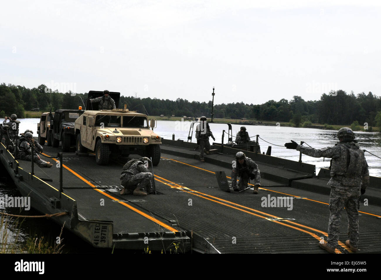 After floating across a large body of water, combat engineers assigned ...